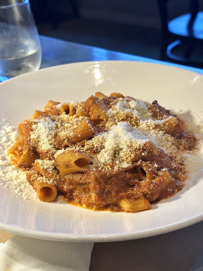 Rigatoni with lamb ragu showered in Parmesan—comfort food that hugs you from the inside. Each bite delivers that "close your eyes and sigh" moment Italian food promises.