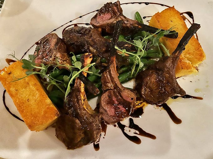 These lamb chops aren't just dinner – they're tiny meat lollipops for grown-ups, perfectly charred and resting on golden polenta cakes like royalty on thrones.