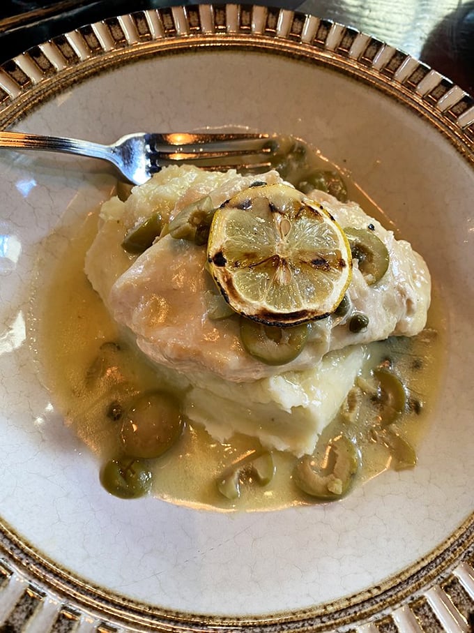 A delicate fish filet bathed in buttery lemon-caper sauce – proof that sometimes the simplest preparations yield the most profound pleasures.