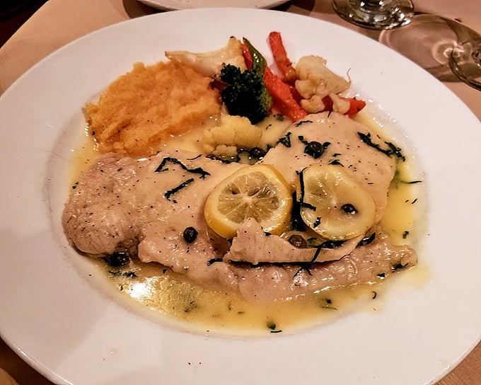 Delicate veal medallions swimming in lemon-butter heaven—proof that simplicity, when done right, is anything but simple.