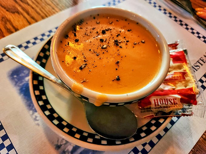 This lobster bisque doesn't just warm your body—it recalibrates your understanding of what soup can be. Comfort in a checkered-rimmed bowl.