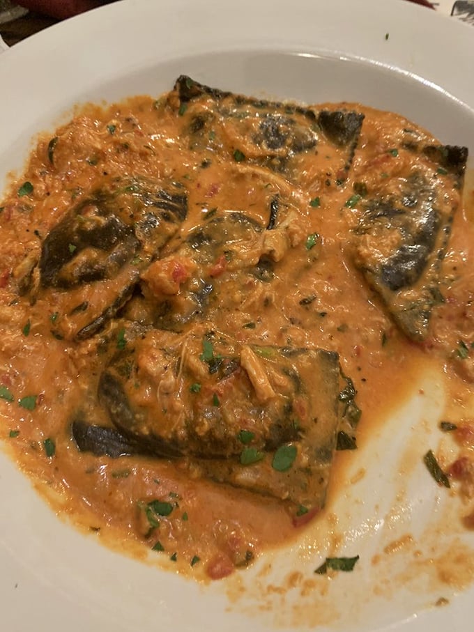 This dish isn't just dinner; it's a masterclass in seafood preparation, with tender fish bathed in a tomato-based sauce that demands bread for sopping.