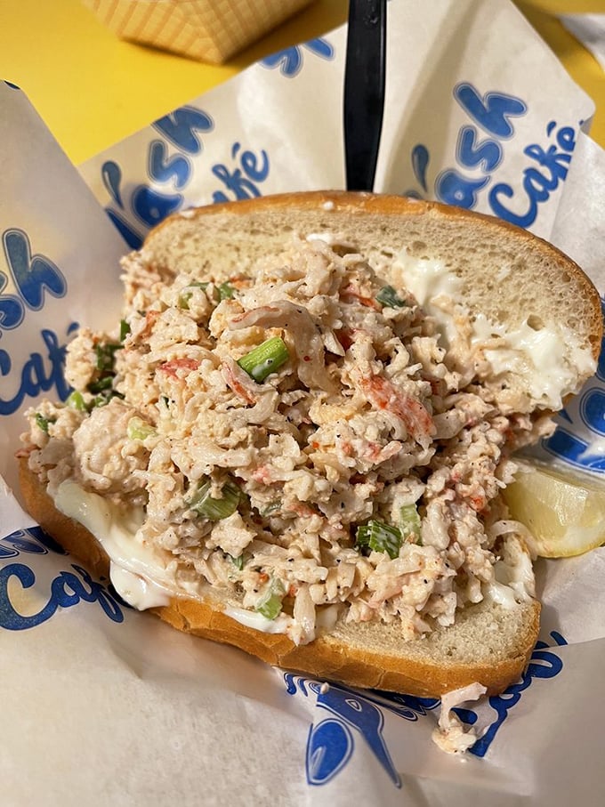 That lobster roll is dressed for success – mayo, fresh greens, and enough lobster to make Maine slightly nervous.