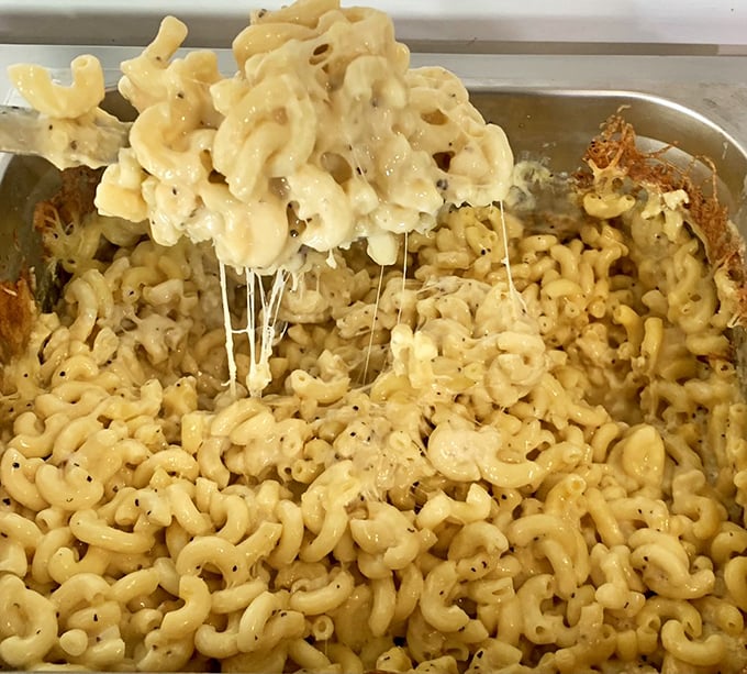 Mac and cheese that stretches like a lazy cat in sunshine – comfort food that's earned its place at the barbecue table.