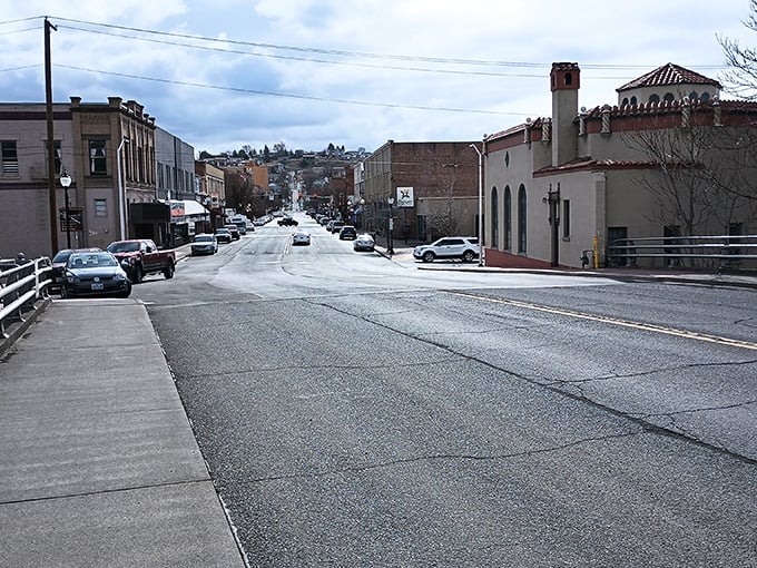 Main Street slopes gently upward, revealing Pendleton's hillside setting. These brick buildings have stories that would fill a Ken Burns documentary.