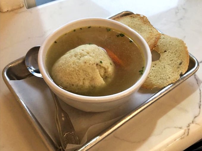 Matzo ball soup that floats like a cloud and hugs your soul like a warm blanket.