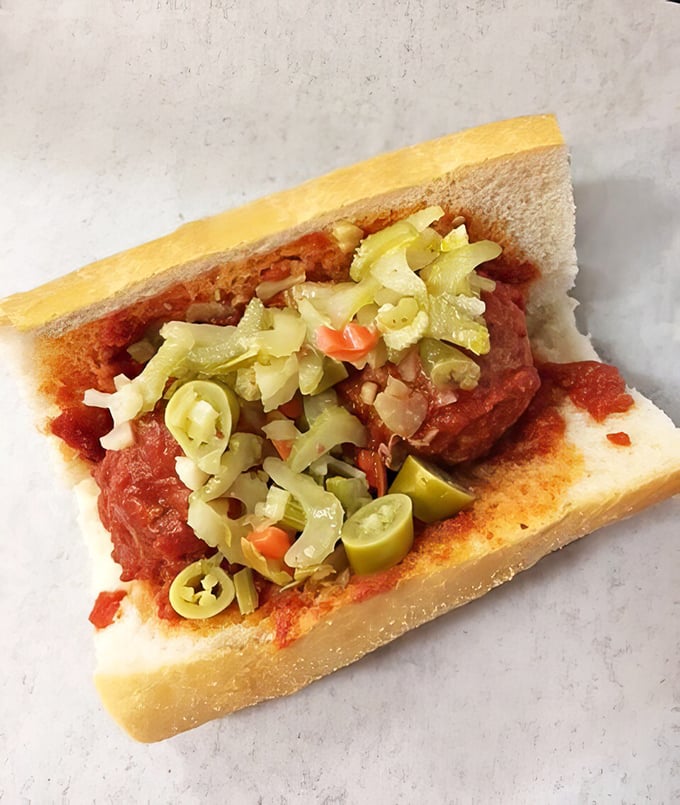 Behold the Italian sausage sandwich with giardiniera—where spicy meat meets tangy vegetables in a handheld symphony that Mozart would have appreciated.