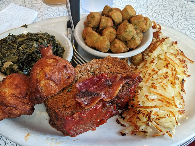 Southern comfort on a plate—meatloaf, greens, and hash browns that would make your grandmother simultaneously proud and jealous.