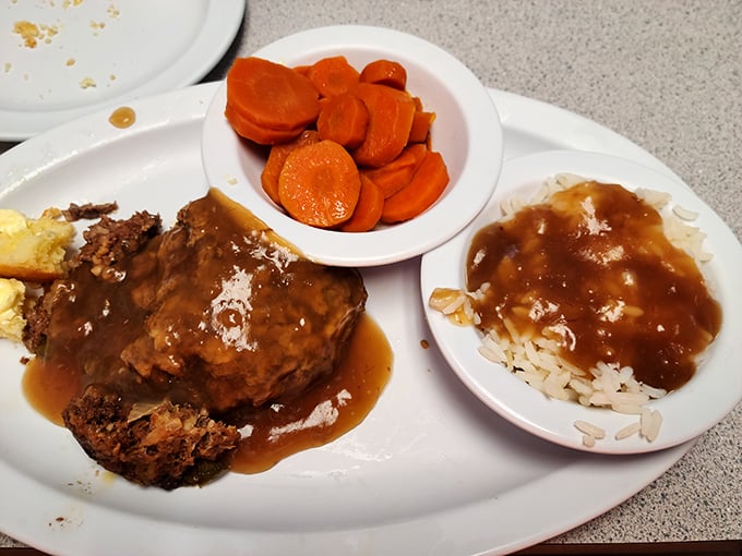 Meatloaf that doesn't apologize for being meatloaf, served with carrots bright enough to guide Santa's sleigh. Comfort food that actually comforts.