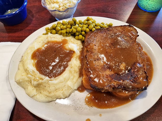 This isn't just meatloaf—it's a masterclass in comfort. Tender, savory, and swimming in gravy that deserves its own fan club.