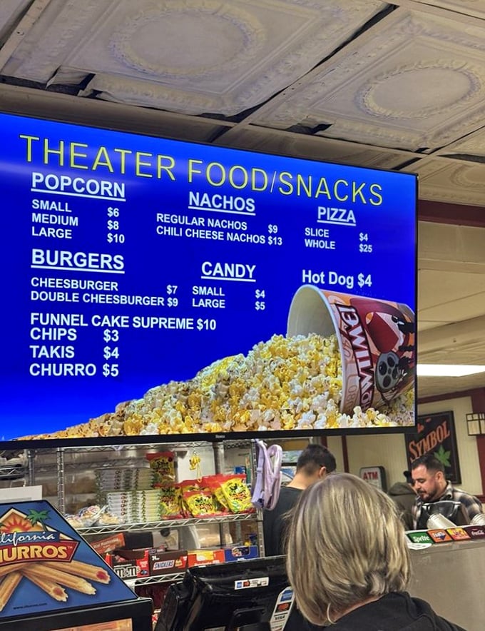 Movie munchies menu board showcasing the classics—where popcorn comes in buckets, not those wimpy bags they give you at multiplexes.