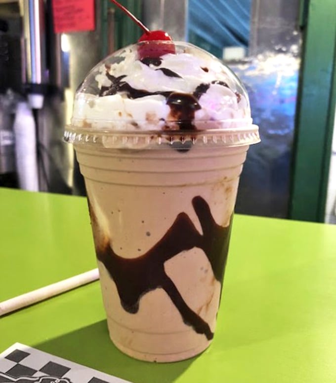 This isn't just a milkshake—it's a work of art. The chocolate swirls are like Jackson Pollock decided to get into the dessert business.