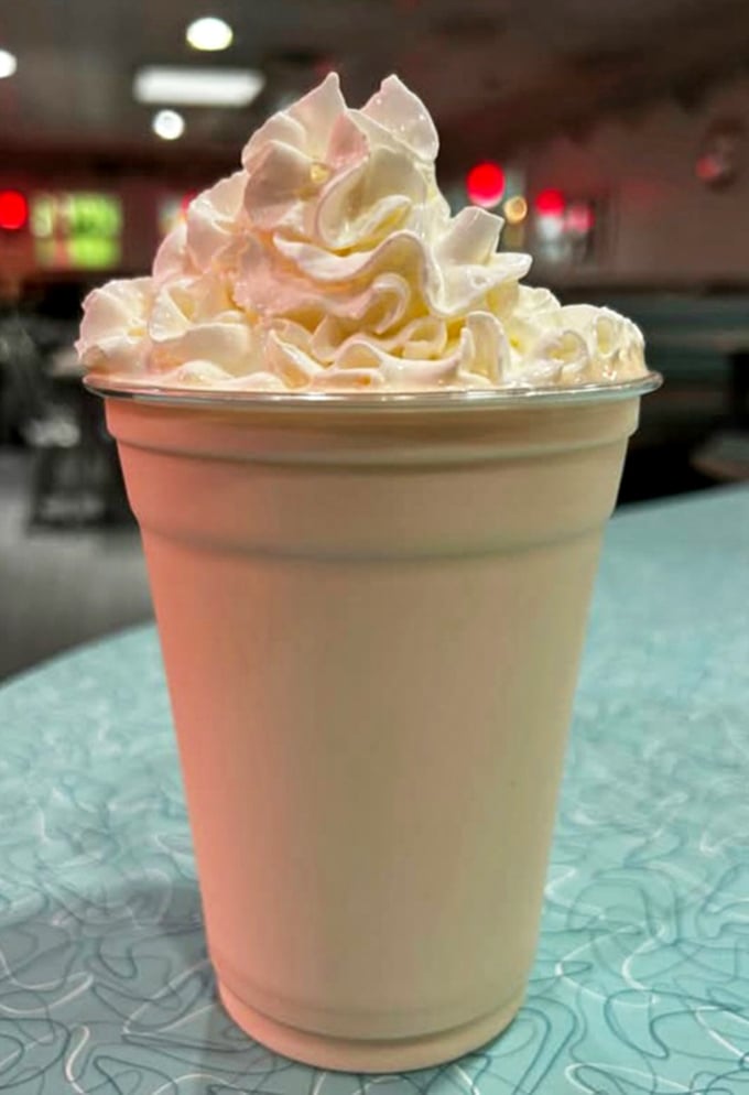 A milkshake so thick it defies gravity – the whipped cream mountain on top is just showing off at this point.