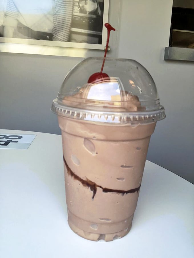The chocolate milkshake arrives like a cool, creamy tower of indulgence—that cherry on top isn't just garnish, it's a promise.
