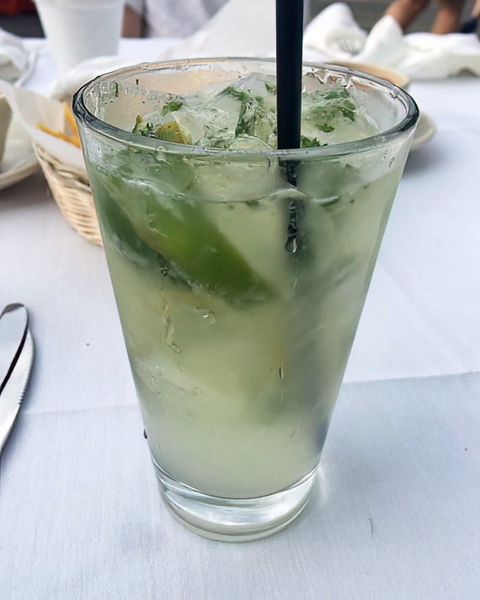This isn't just any mojito – it's summer in a glass, with fresh mint leaves dancing among ice cubes like tiny refreshing ballerinas.