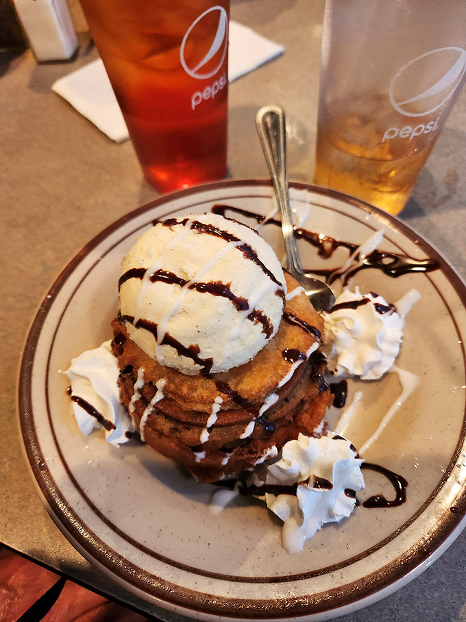 Behold the fried Oreo masterpiece – where childhood nostalgia meets adult sophistication in a tower of sweet rebellion drizzled with chocolate.