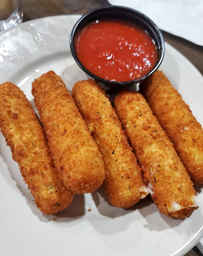 Golden-brown mozzarella sticks – the universal language of "yes, you deserve this" – stand at attention beside their marinara companion.