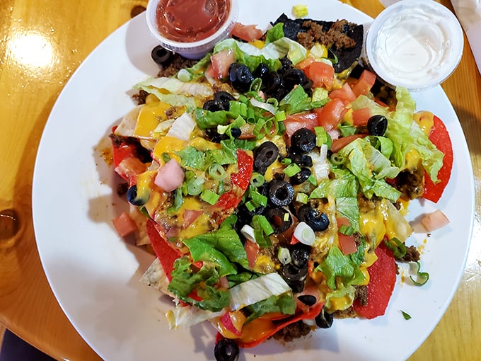 Nachos that don't understand the concept of personal space—every chip is smothered in toppings as if afraid of being caught underdressed at the party.