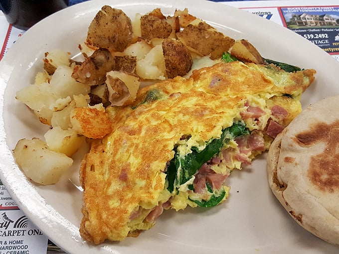 This isn't just an omelet—it's a masterpiece of morning architecture, stuffed with ham and spinach that actually makes you feel virtuous.