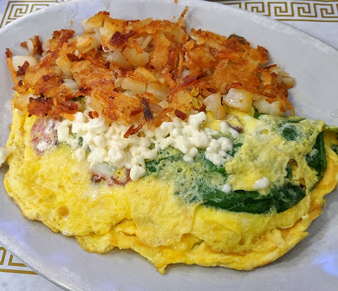 This isn't just an omelet—it's a golden envelope of eggs delivering a love letter of spinach, cheese, and perfectly crisped hash browns.