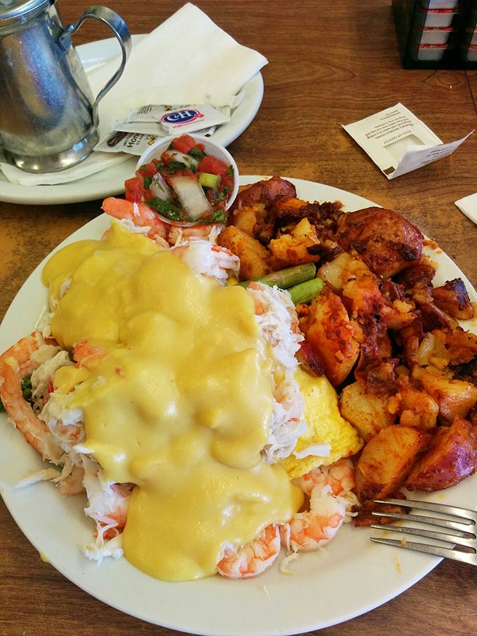 This isn't just breakfast, it's a seafood celebration – crab and eggs performing a sunrise ballet beneath a golden hollandaise waterfall.
