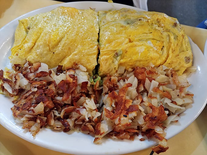 This isn't just an omelet—it's an architectural achievement. Paired with hash browns so perfectly crispy they deserve their own fan club.