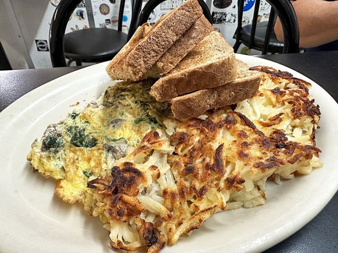 The Hippie Hash isn't just breakfast, it's a cultural institution—crispy potatoes supporting a colorful democracy of vegetables and cheese with toast standing by for support.