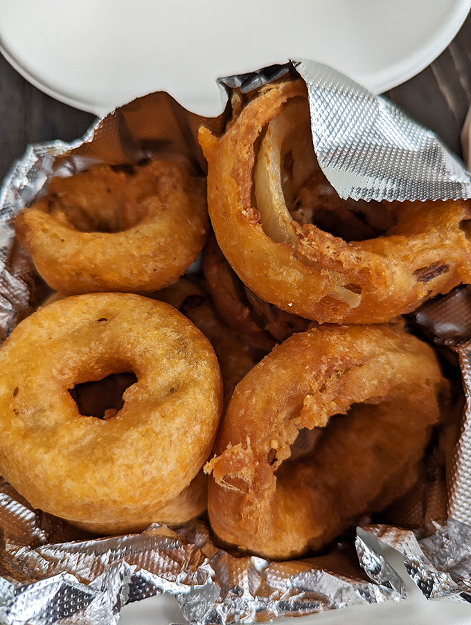 Golden-brown onion rings with that perfect crunch-to-tenderness ratio. These aren't just side dishes; they're crispy halos of happiness that deserve their own fan club.