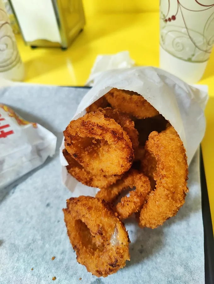 Golden-brown onion rings that shatter with each bite—the kind that make you wonder why anyone bothers with those fancy appetizers elsewhere.