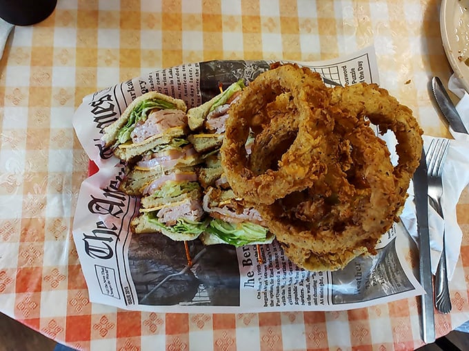 A club sandwich and onion rings served on newspaper—because good food is the only headline that matters in Centerville.