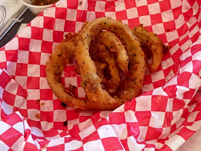 Onion rings that shatter with each bite – perfectly seasoned circles of joy that make you wonder why vegetables ever bothered being healthy.
