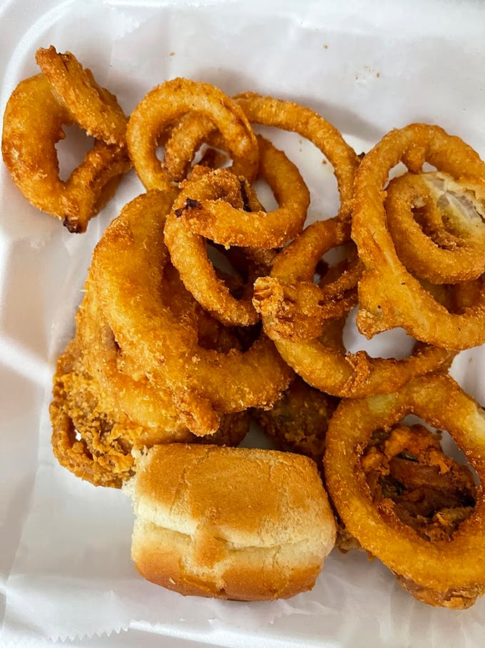 Onion rings that snap with that perfect crunch – the kind that make conversation stop mid-sentence while everyone at the table reaches for more.