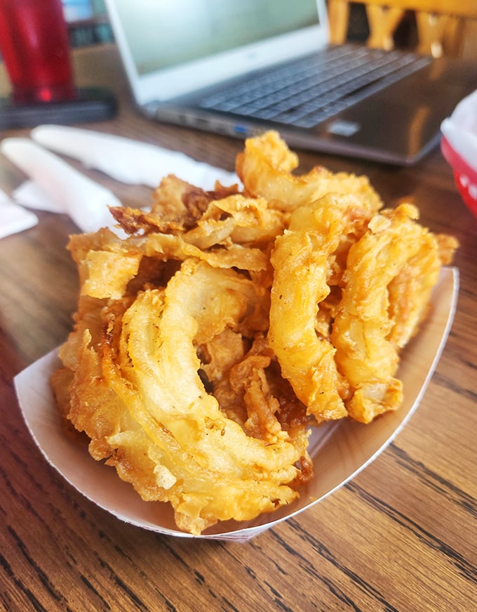 Onion rings so perfectly golden and crispy, they deserve their own Instagram account. The kind worth fighting over with your dining companions.