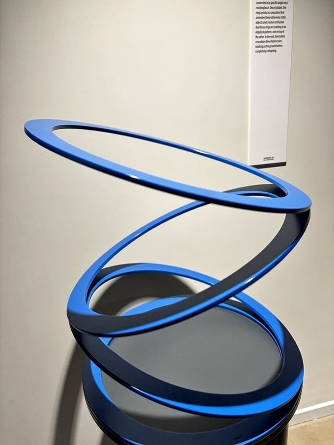 This blue spiral sculpture isn't just art—it's a mathematical mind-bender that makes you question whether Escher moonlighted as an interior decorator.