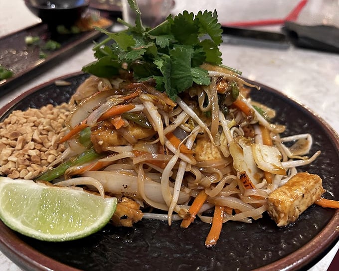This pad Thai isn't playing around—tender noodles, fresh lime, and crunchy peanuts create the holy trinity of texture that makes taste buds stand at attention.