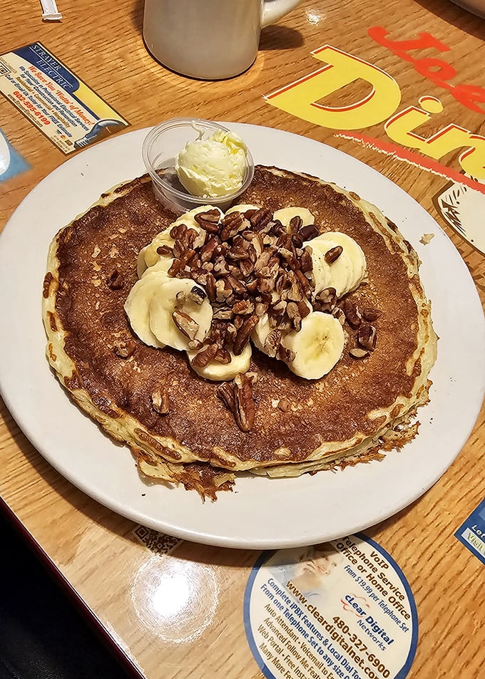This pancake, topped with bananas and pecans, isn't trying to win Instagram—it's trying to win your heart, one fluffy bite at a time.
