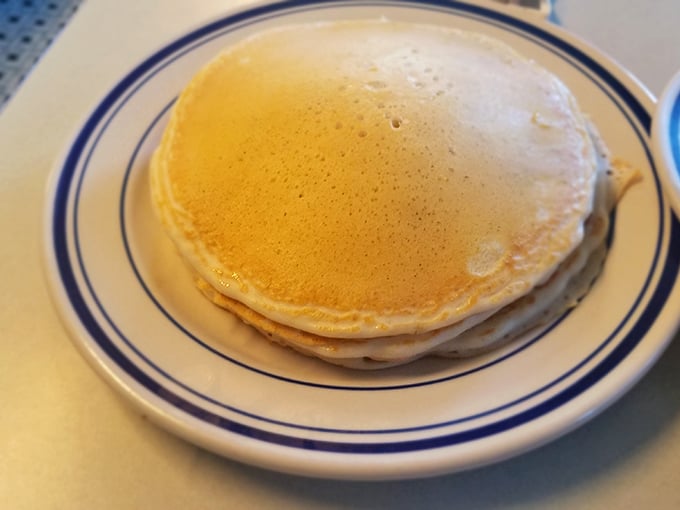 Golden pancakes that look like they're auditioning for a breakfast commercial—fluffy, perfectly round, and ready for their syrup shower.