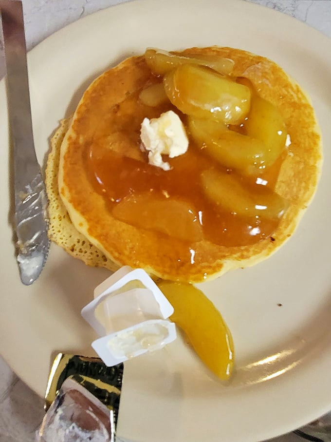 Pancakes that don't need Instagram filters—just real butter melting into golden pools and apples that actually taste like apples.