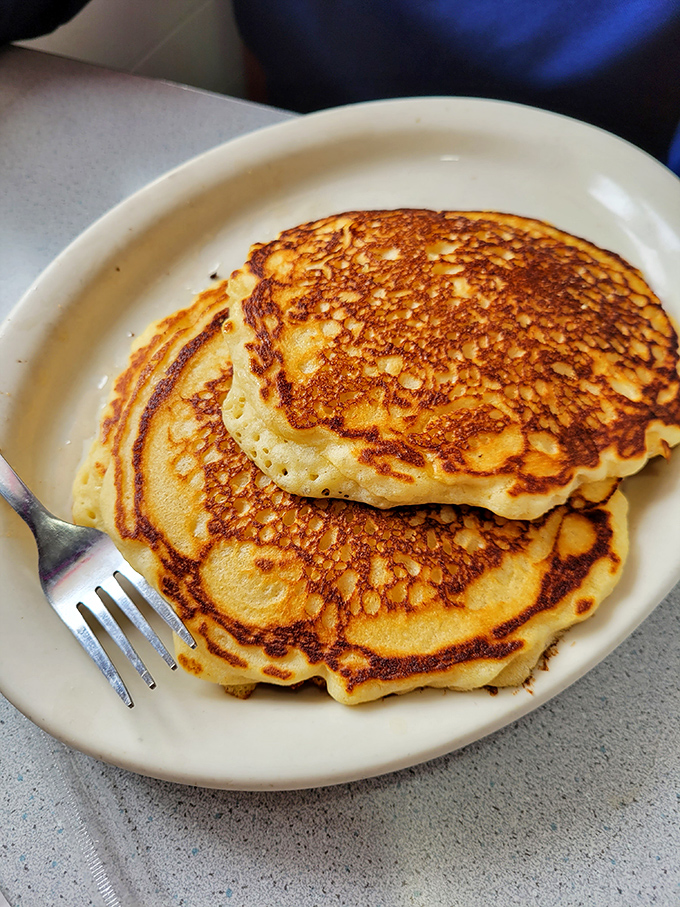Golden pancakes with the perfect crisp-to-fluffy ratio – the kind that make you question why anyone would ever skip breakfast.
