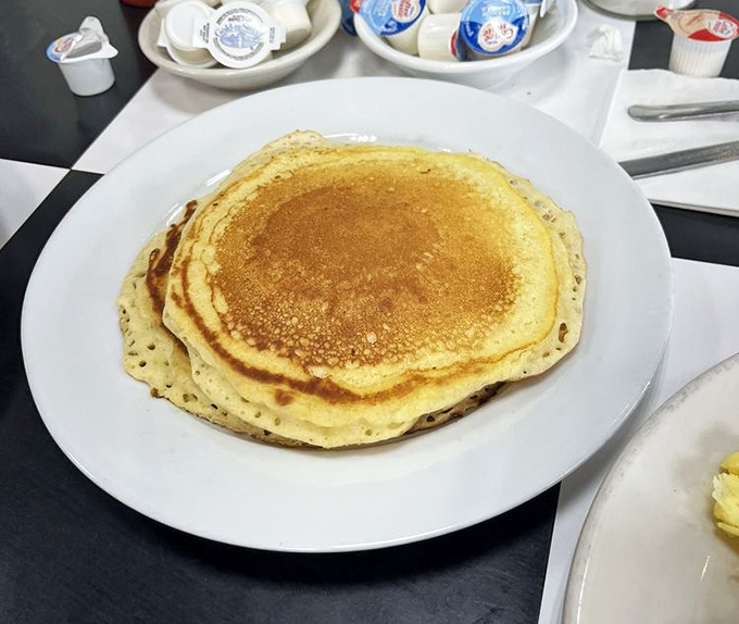 This pancake isn't just big—it's the size of your childhood dreams. Golden, fluffy, and ready for its maple syrup waterfall.