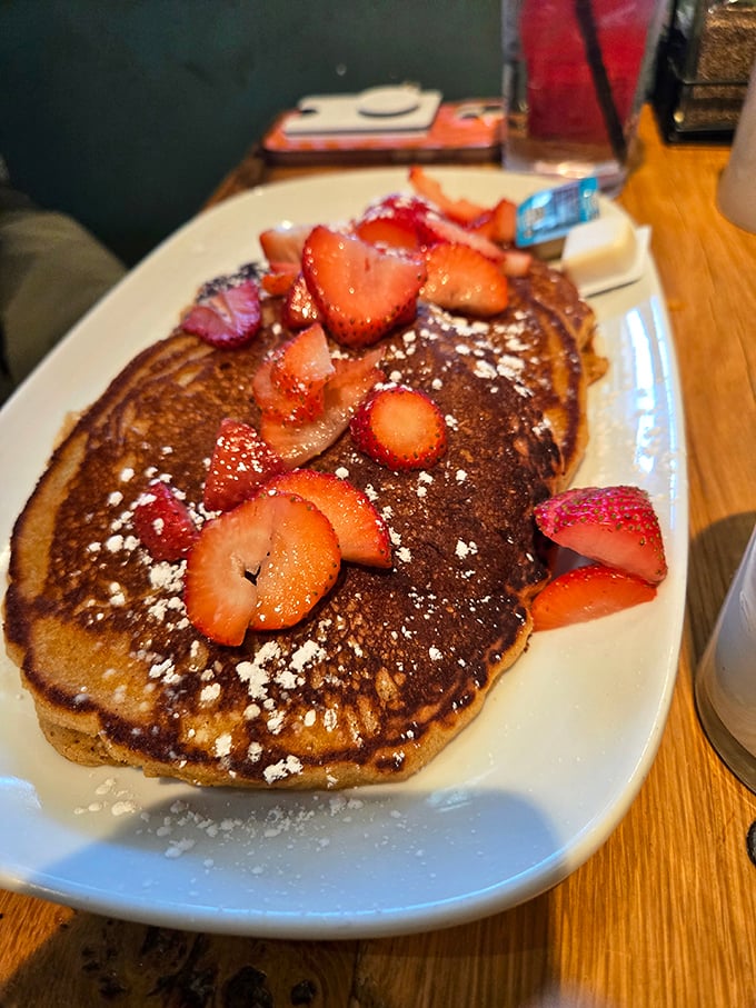 These aren't just pancakes—they're fluffy golden discs of joy, topped with fresh strawberries that somehow make you feel virtuous about eating dessert for breakfast.
