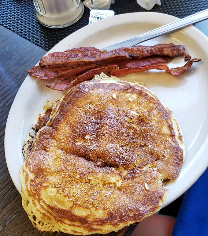 That pancake isn't just big; it's the breakfast equivalent of a solar eclipse – magnificent, awe-inspiring, and demanding your complete attention.