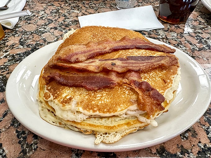 Pancakes stacked higher than your weekend to-do list, with bacon that's achieved that perfect crispy-chewy harmony we all seek in life.