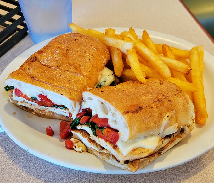 This sandwich isn't just lunch—it's architecture. Layers of fresh ingredients stacked with structural integrity that would make Frank Lloyd Wright nod in approval.