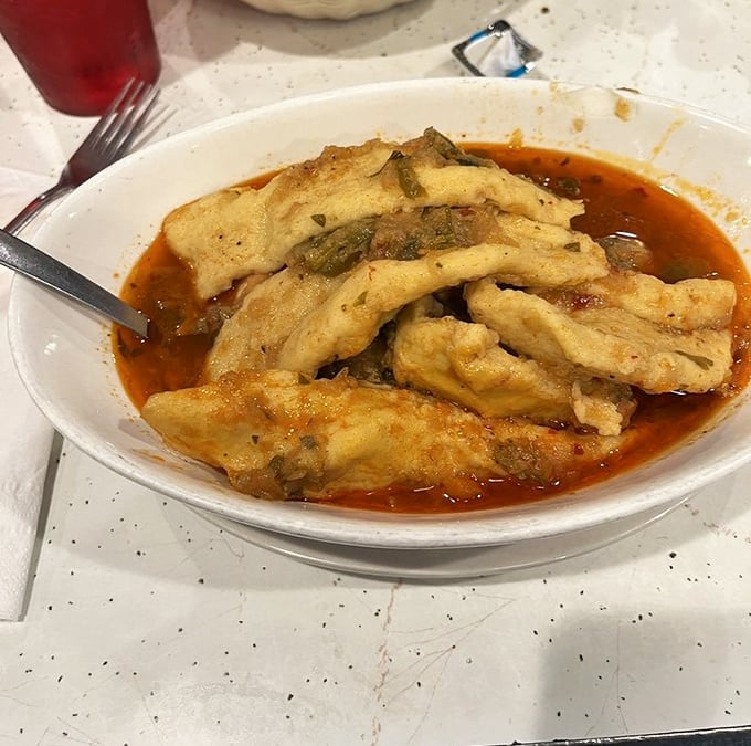 Chicken paprikash swimming in vibrant sauce – proof that sometimes the best things come in unassuming bowls.