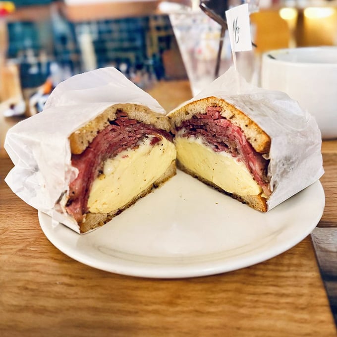 The pastrami sandwich—a skyscraper of meat and egg that makes you wonder if your mouth will actually unhinge like a python's.