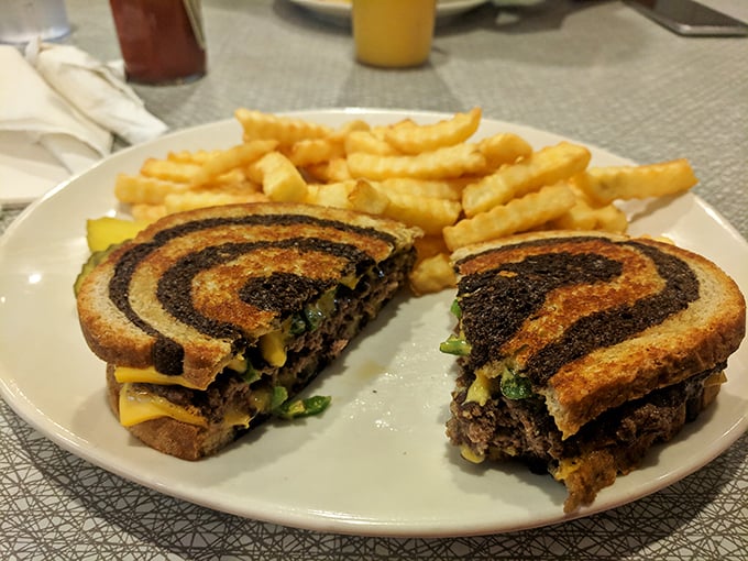 Behold the legendary patty melt—where caramelized onions, melted cheese, and seasoned beef unite on grilled rye in what can only be described as sandwich nirvana.