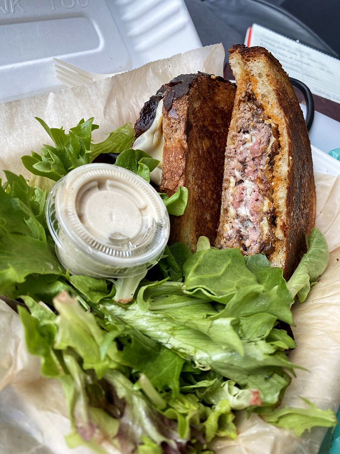 The patty melt reveals its inner beauty—perfectly pink, perfectly melty. It's like seeing the Sistine Chapel of sandwiches.