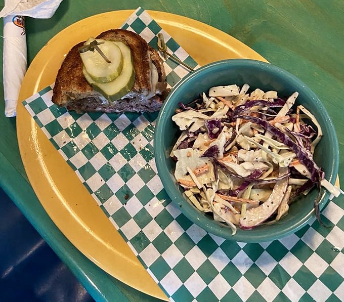 The patty melt—that glorious hybrid of burger and grilled cheese—meets its perfect companion in a side of fresh, crunchy coleslaw. Comfort food, elevated.
