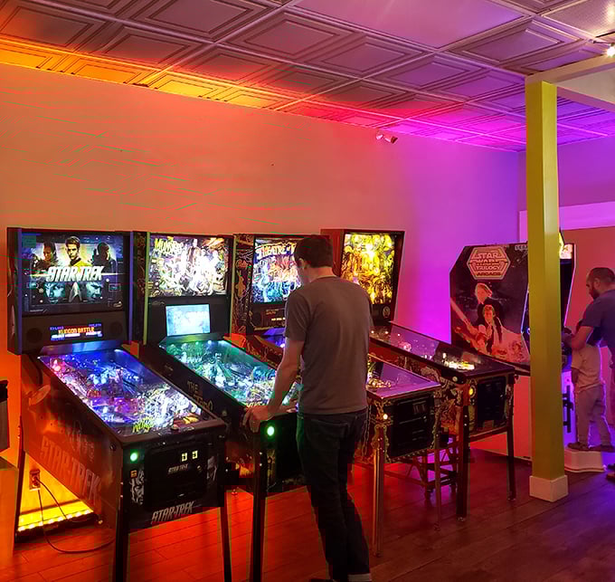 The hypnotic lights of pinball machines create their own galaxy—each flipper click a tiny rebellion against growing up.